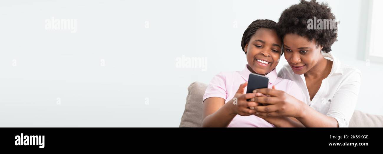 African Parent And Kid Using Phone Technology Stock Photo - Alamy