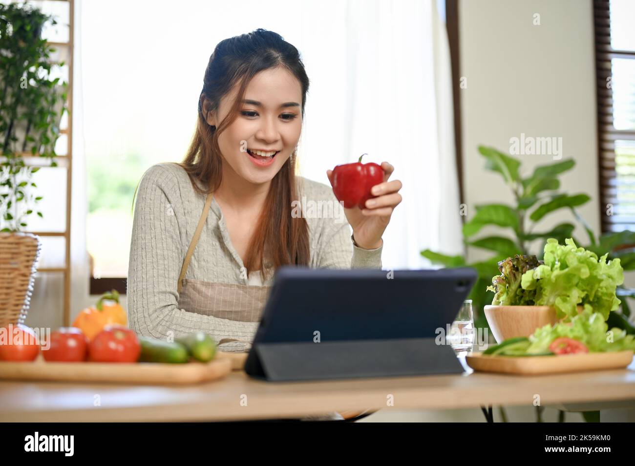 Pretty and charming young Asian female food blogger or nutritionist ...