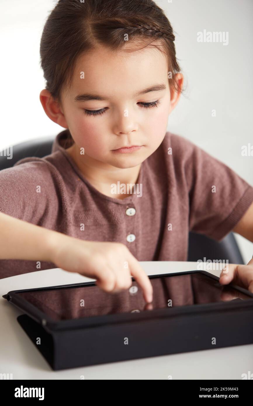 Education and entertainment at her fingertips. an adorable little girl ...