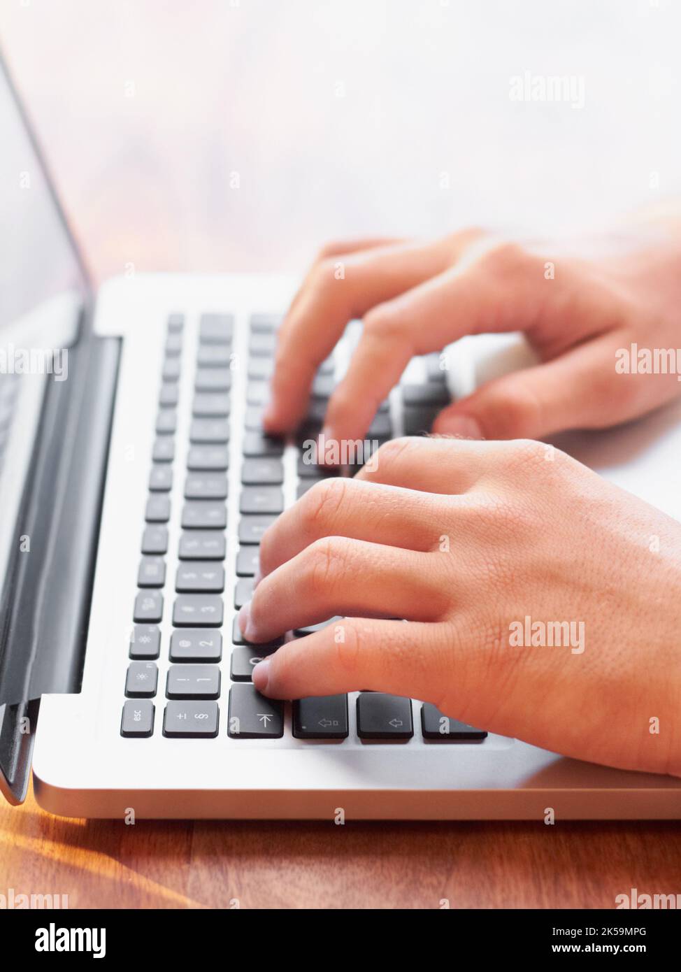 Keyboard strokes get the job done. a businessmans hands on a laptop ...