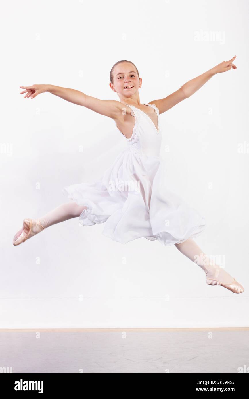 Portrait of youthful poise. a young ballerina leaping across the floor ...