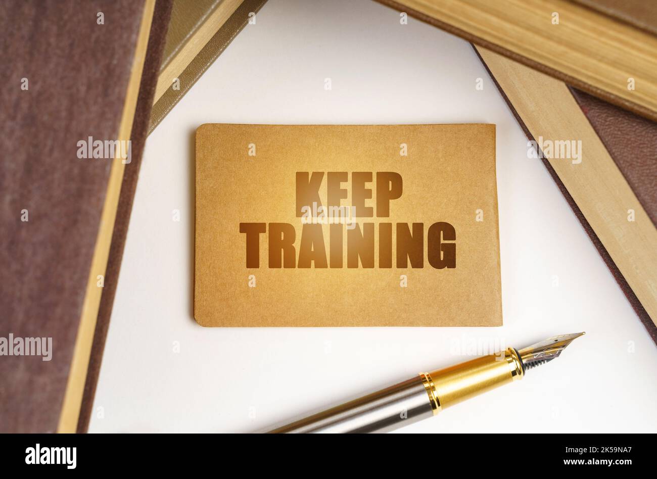 Education and business concept. Next to the books lies a pen and a sign ...