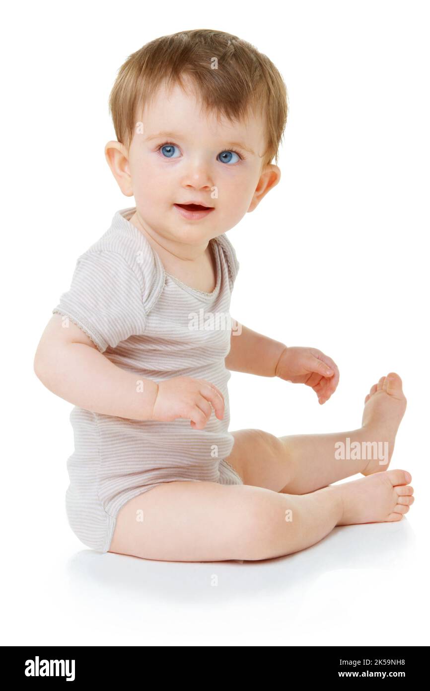 Shes a cute baby girl. A cute baby girl sitting down isolated on white ...