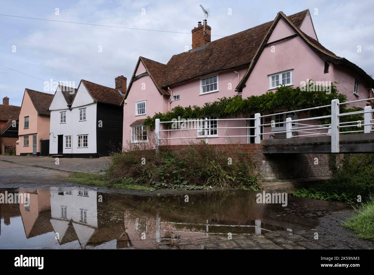 View of colored houses along Main street mirrored in the water of the ...