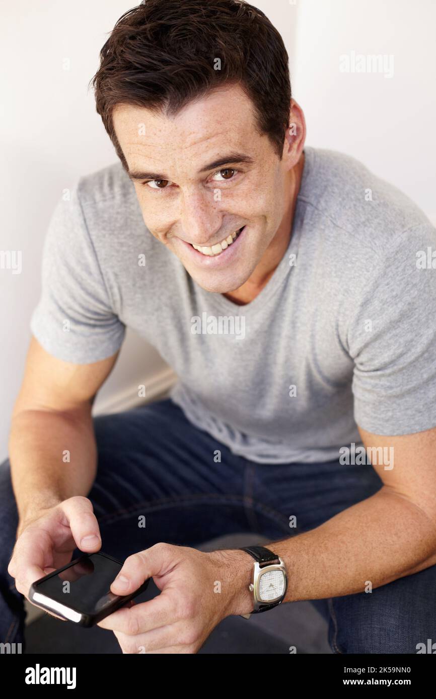 Social networking. Portrait of a handsome young man sending a text ...