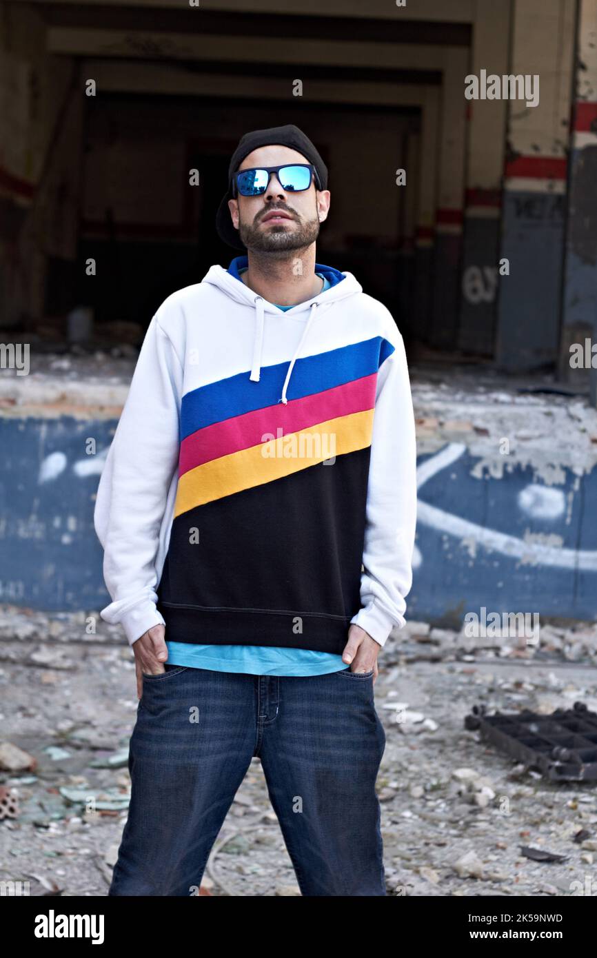 Badass to the core. A man standing in junk yard with sunglasses and a ...