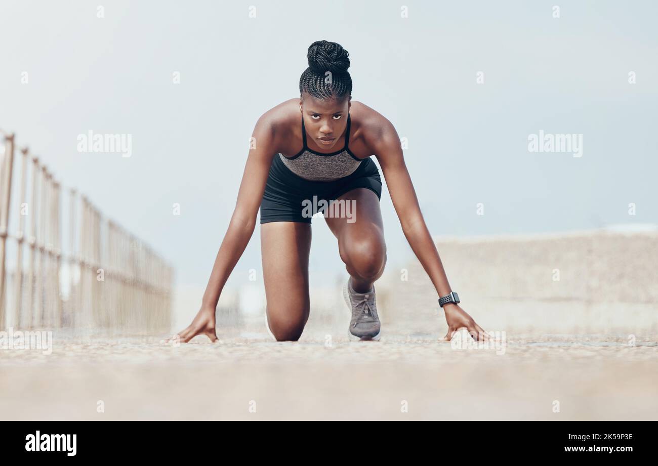 Fitness, runner and woman start running workout along beach, cardio and speed training. Sports ...