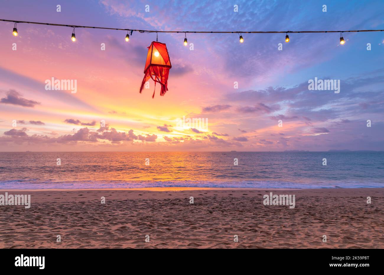 The red beach lantern lamp is hanging on cable with lightbulb. Beach ...