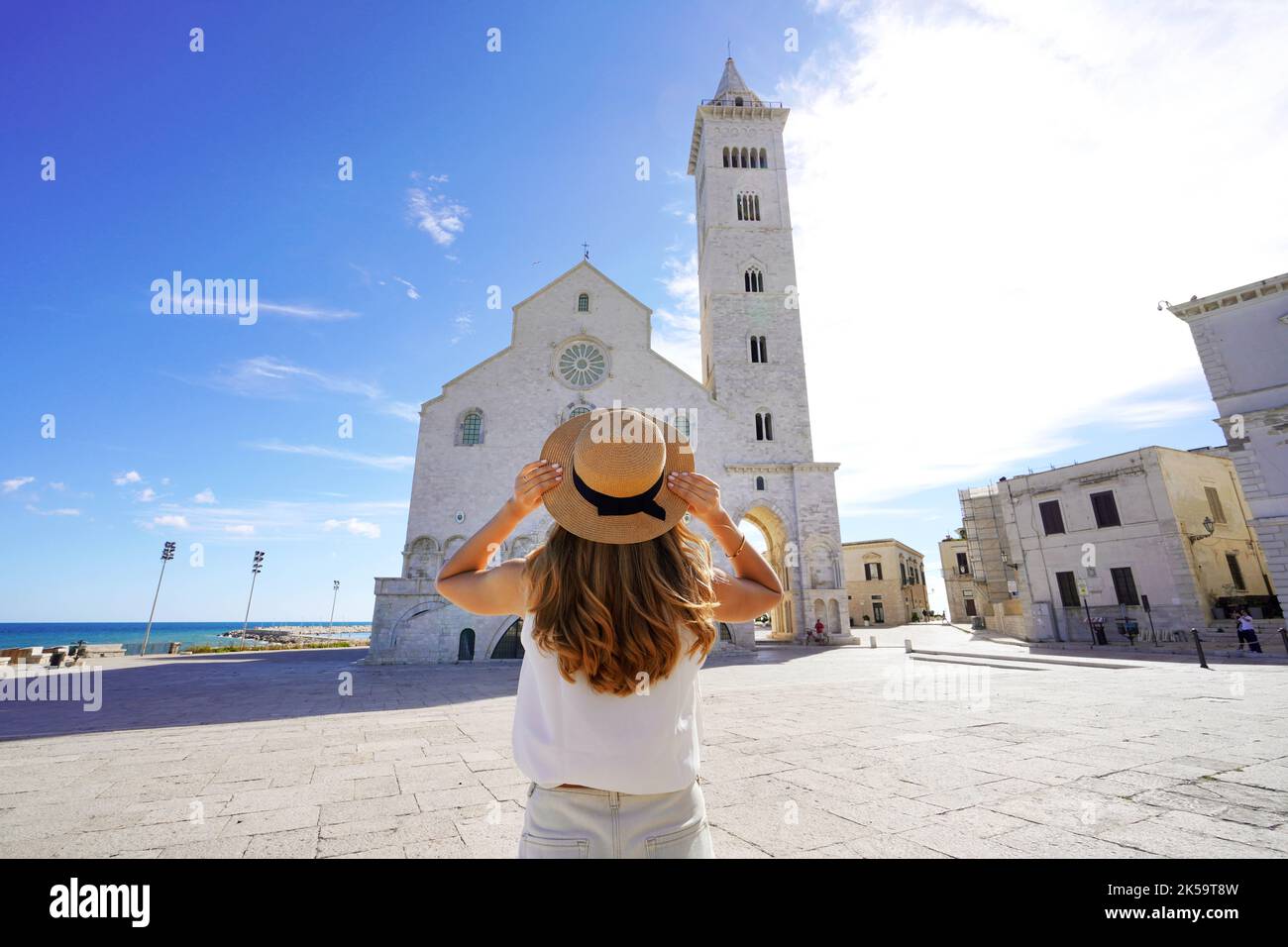 Holidays in Apulia, Italy. Back view of beautiful tourist woman holding ...