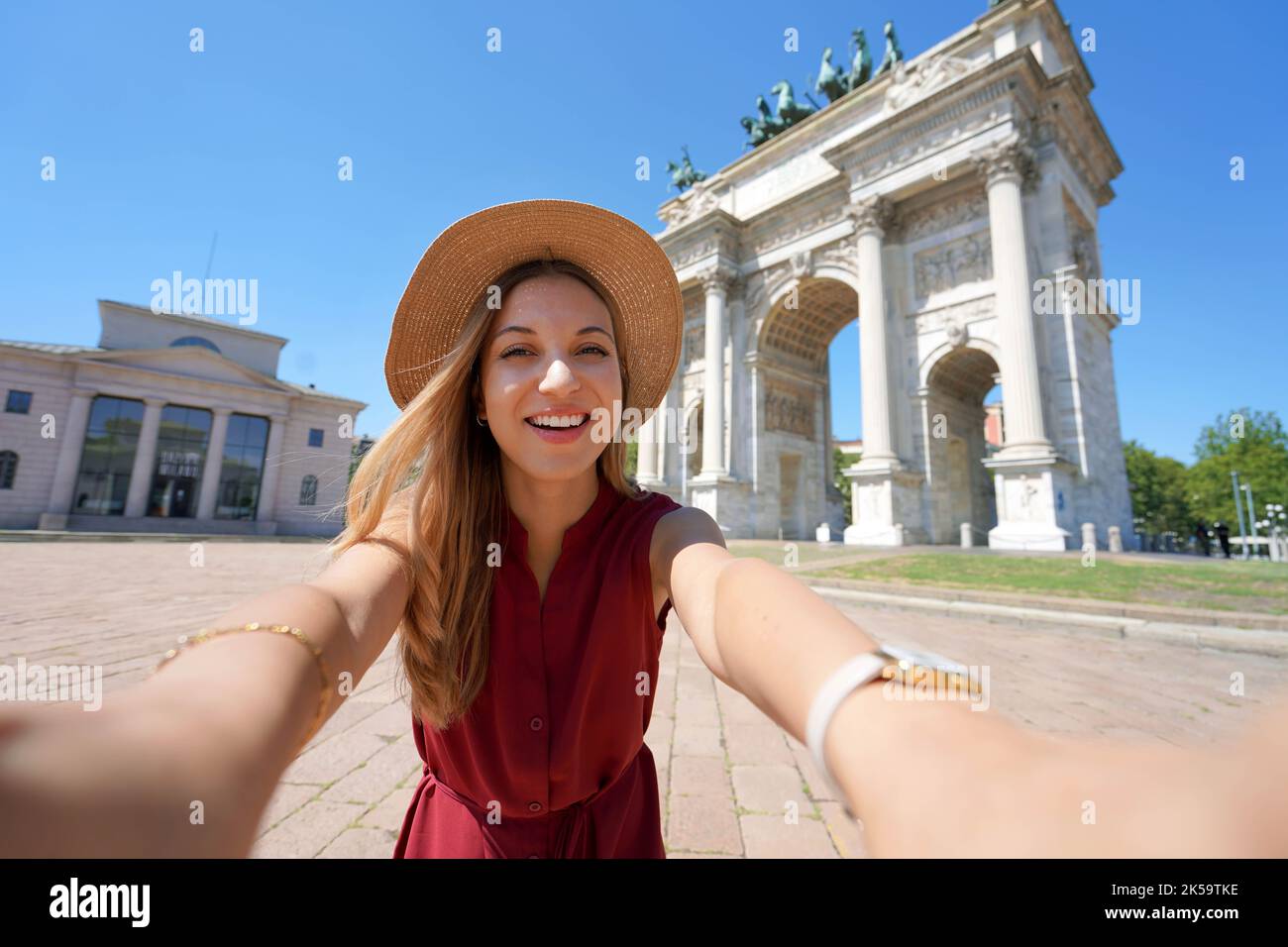 Beautiful smiling traveler girl takes self portrait in Milan, Italy ...