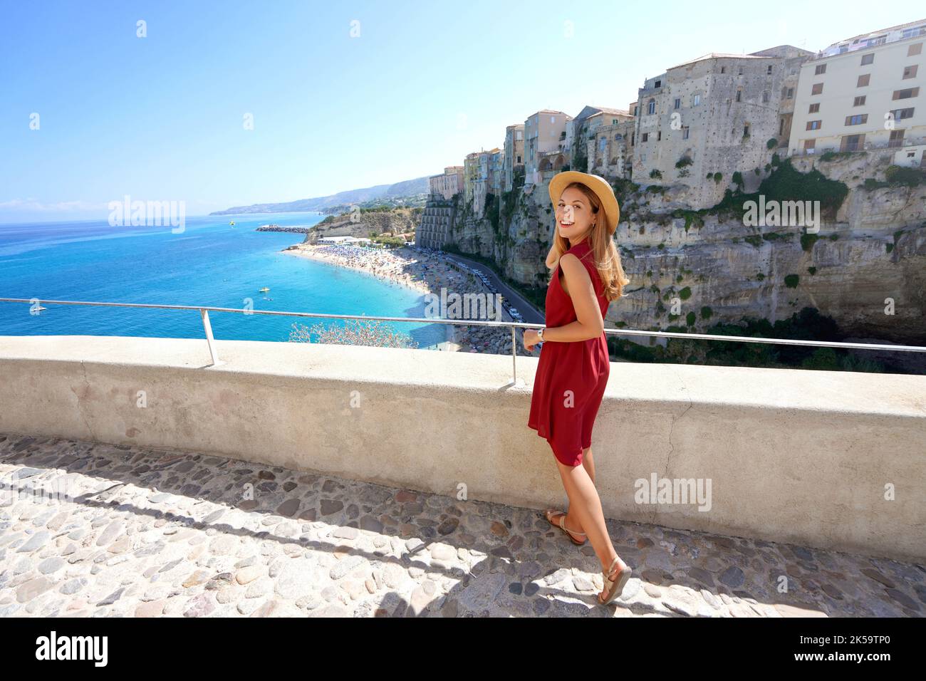Full length of girl in Tropea, Italy. Beautiful young tourist woman walking in Tropea village on ...