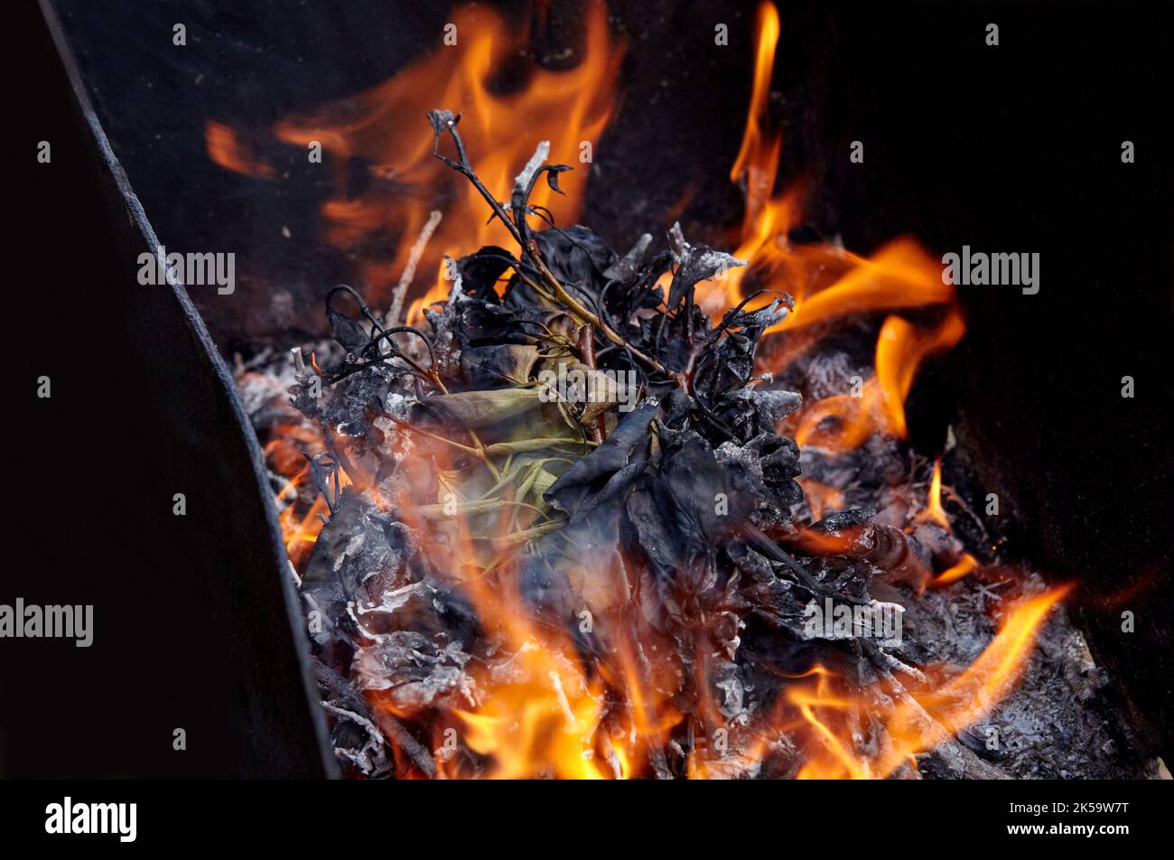 Burning red hot sparks fly from fire. Barbecue gril with glowing and ...