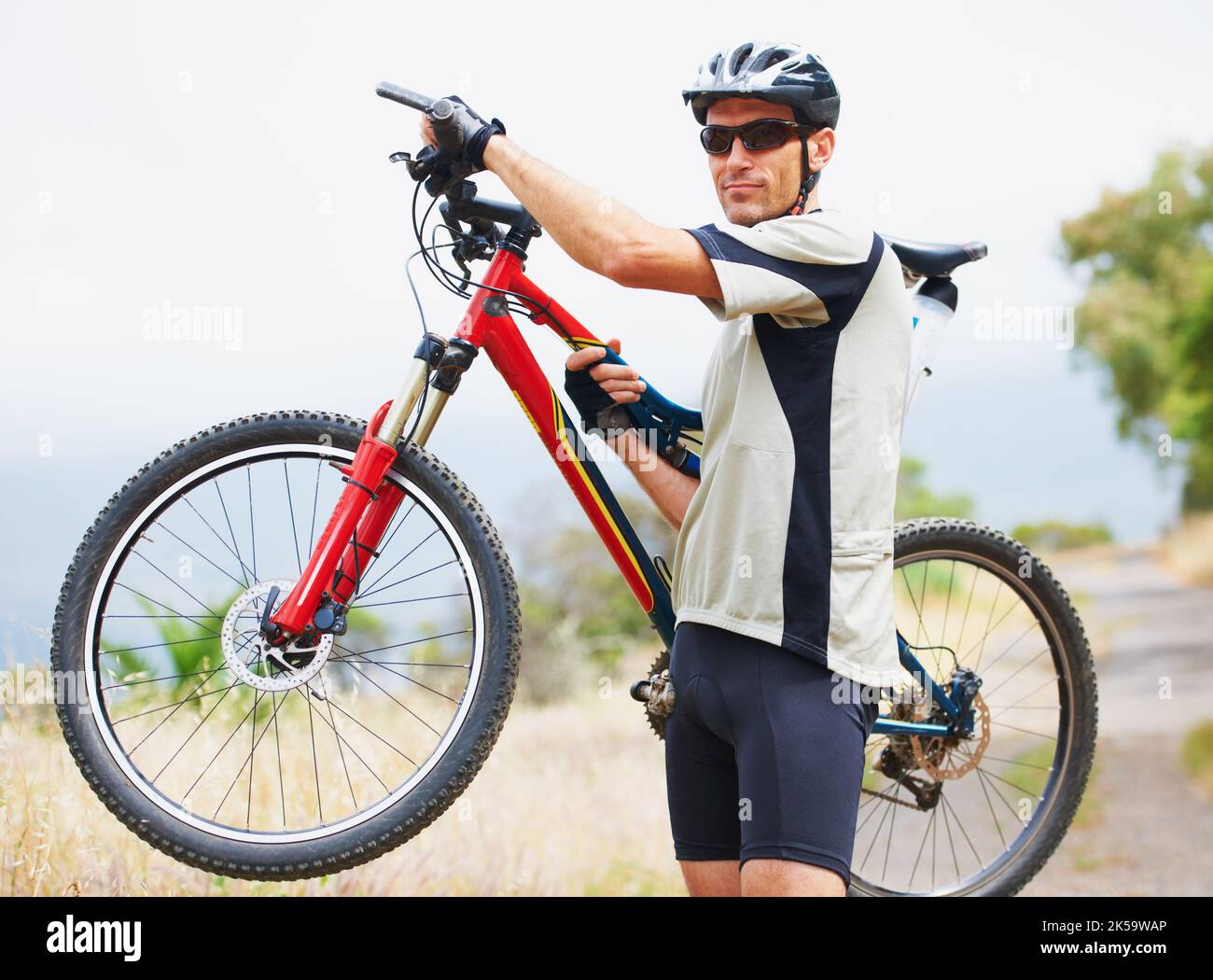 Manly mountain biker. a sportsman carrying his mountain bike Stock ...