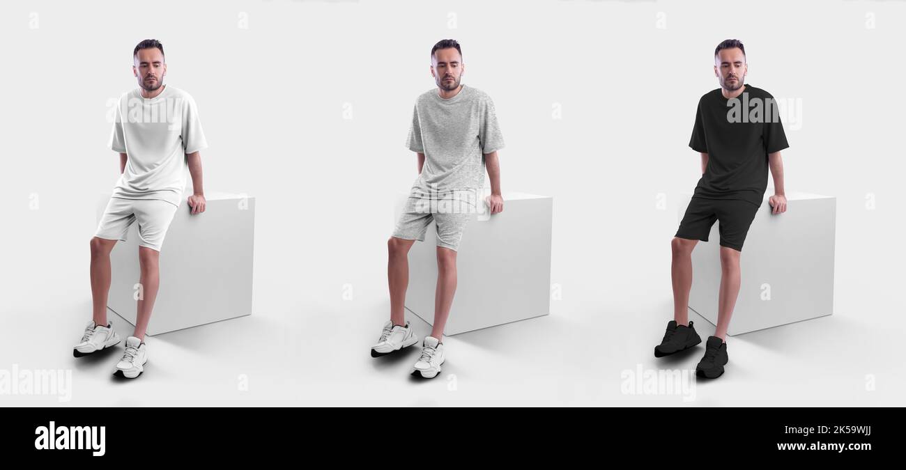 Mockup of white, black and gray men's suit oversized t-shirt on shorts on man on cube. Clothing ...