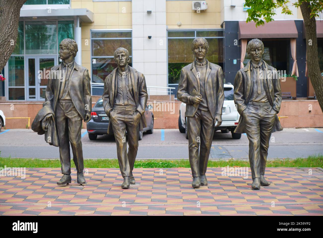 A bronze statue of the iconic pop, rock band, The Beatles, walking. In ...