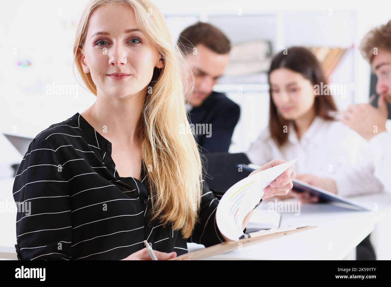 Beautiful smiling cheerful girl at workplace look in camera Stock Photo ...