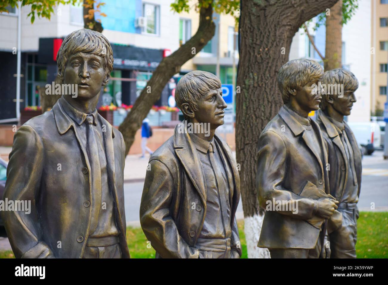 A bronze statue of the iconic pop, rock band, The Beatles, walking. In ...