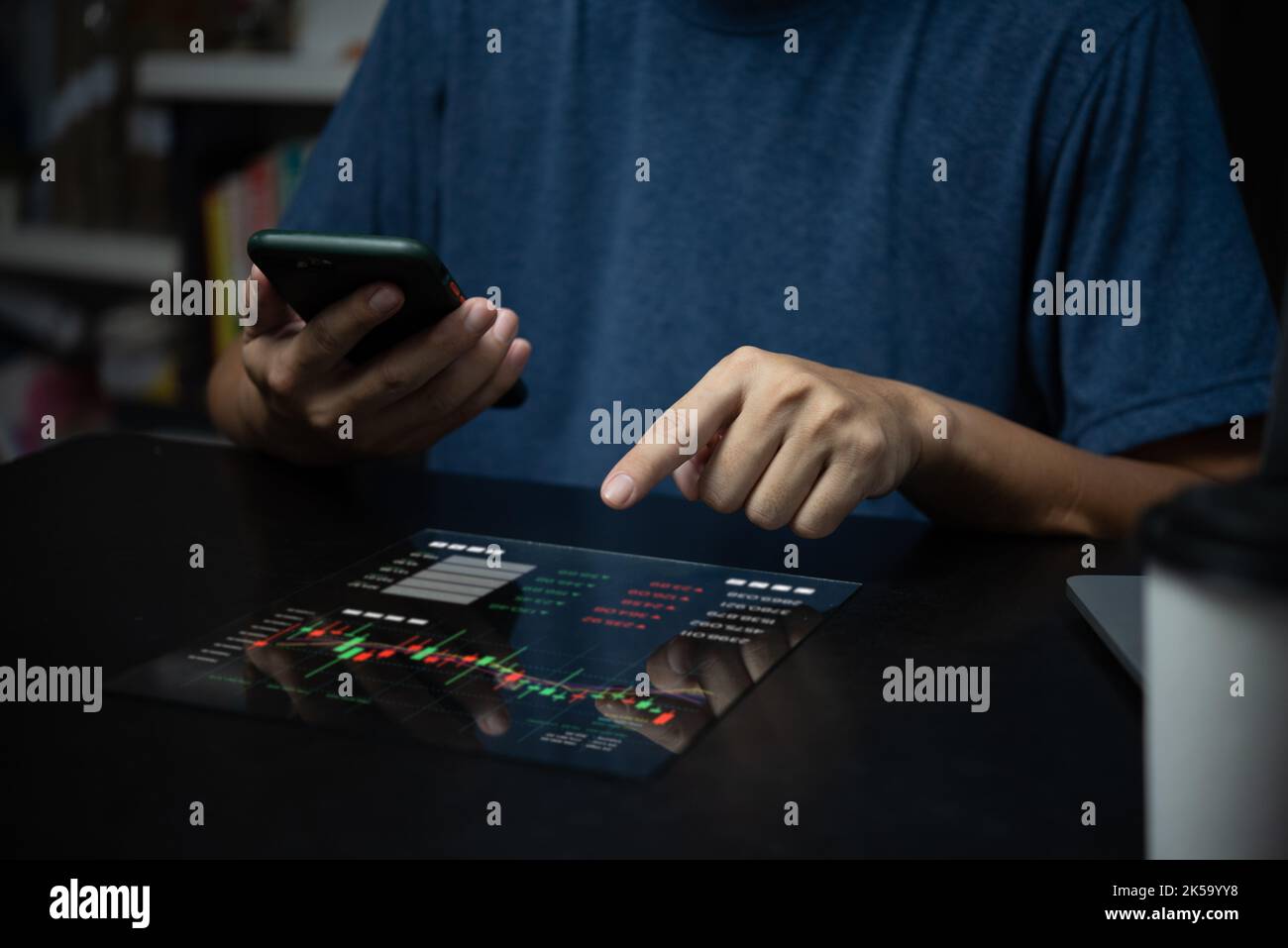 Businessman holding smartphone and virtual screen graph stock market ...