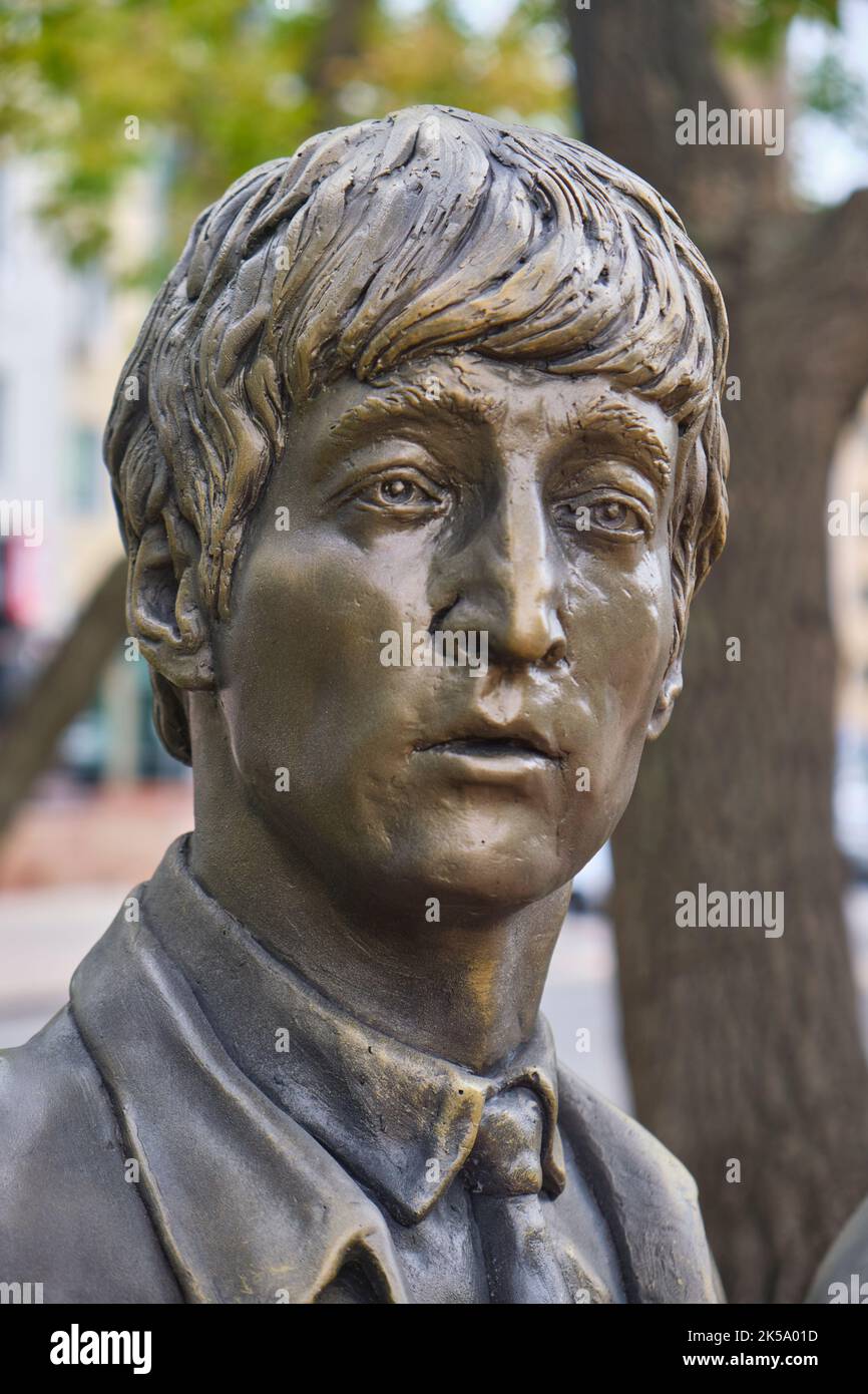 Detail of guitarist John Lennon from a bronze statue of the iconic pop ...