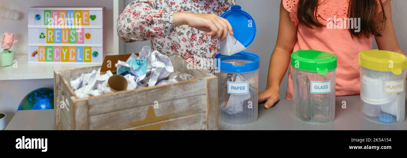 Student recycling cardboard on selective trash bin in ecology classroom ...