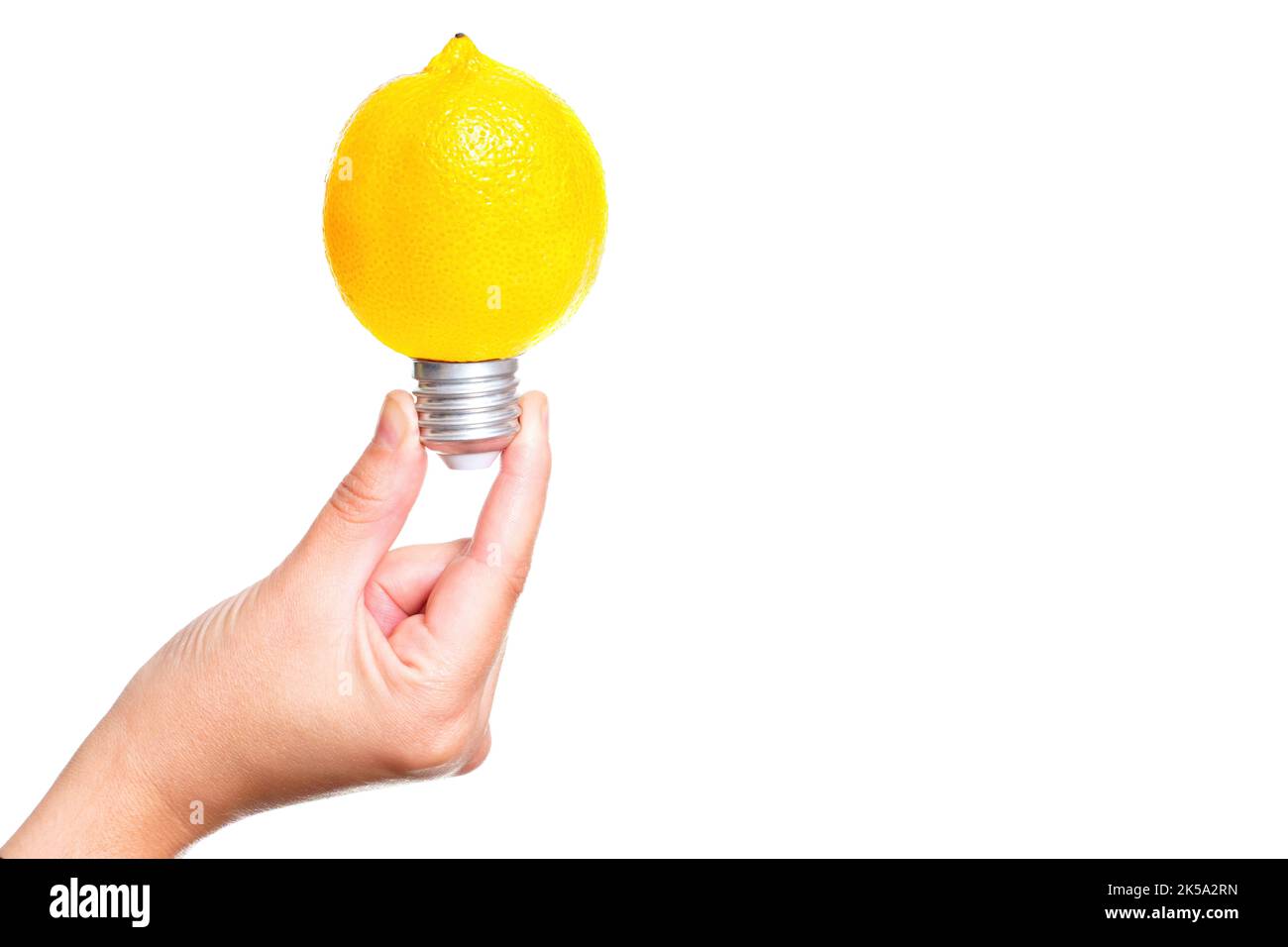 Light bulb made from a fresh lemon in hand isolated on white background ...