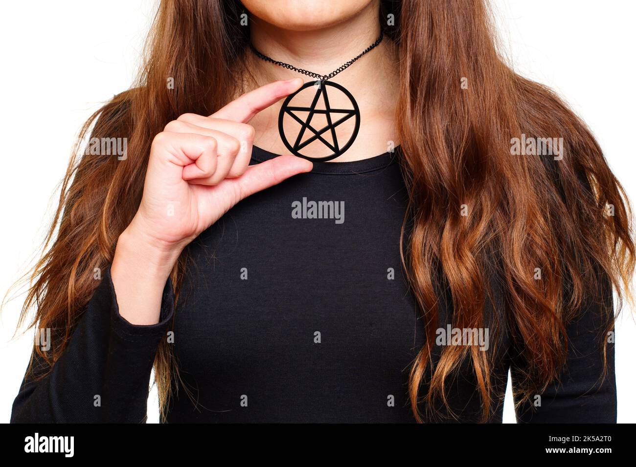 Lady wearing a black long sleeve dress showing a large pentagram ...