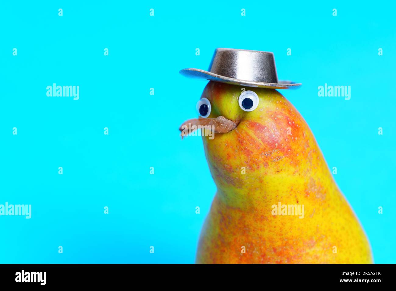 Close-up of a plump kiwi-bird like pear character with googly eyes ...