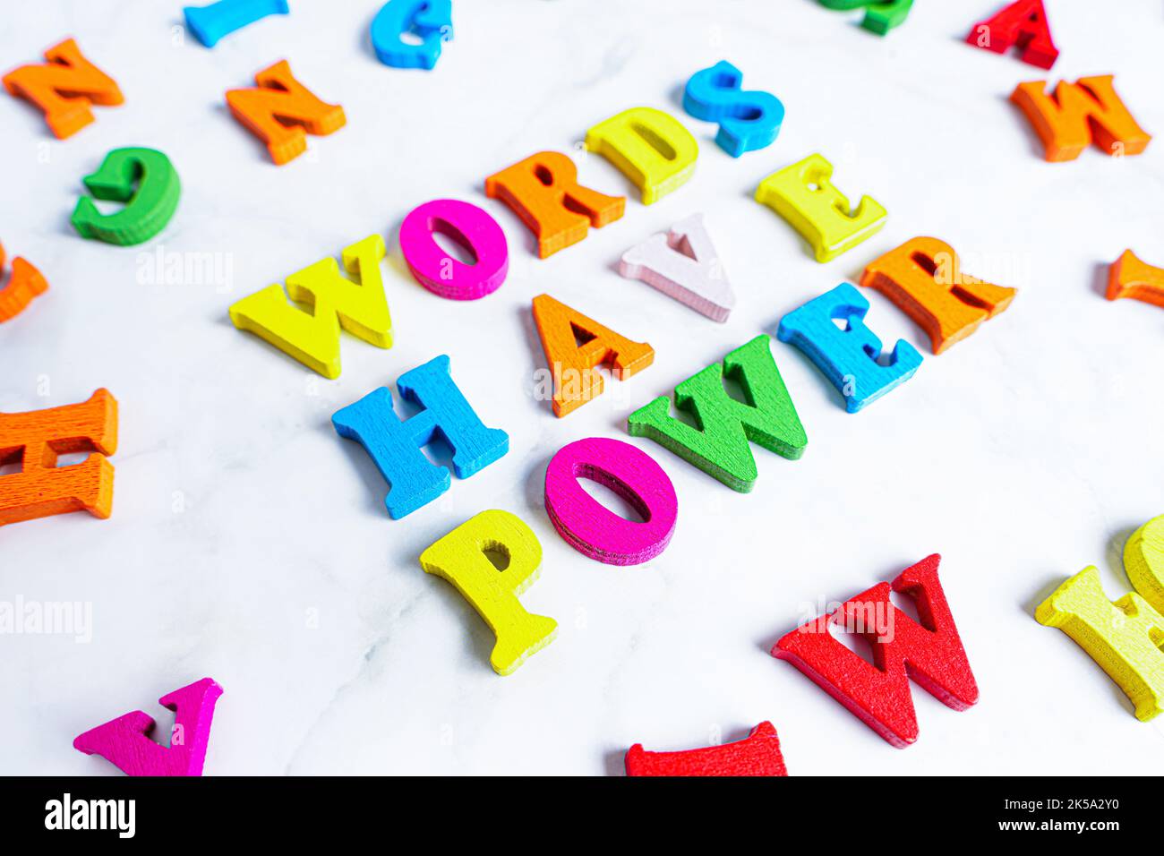 Multicolored wooden letter characters arranged into the wording WORDS ...