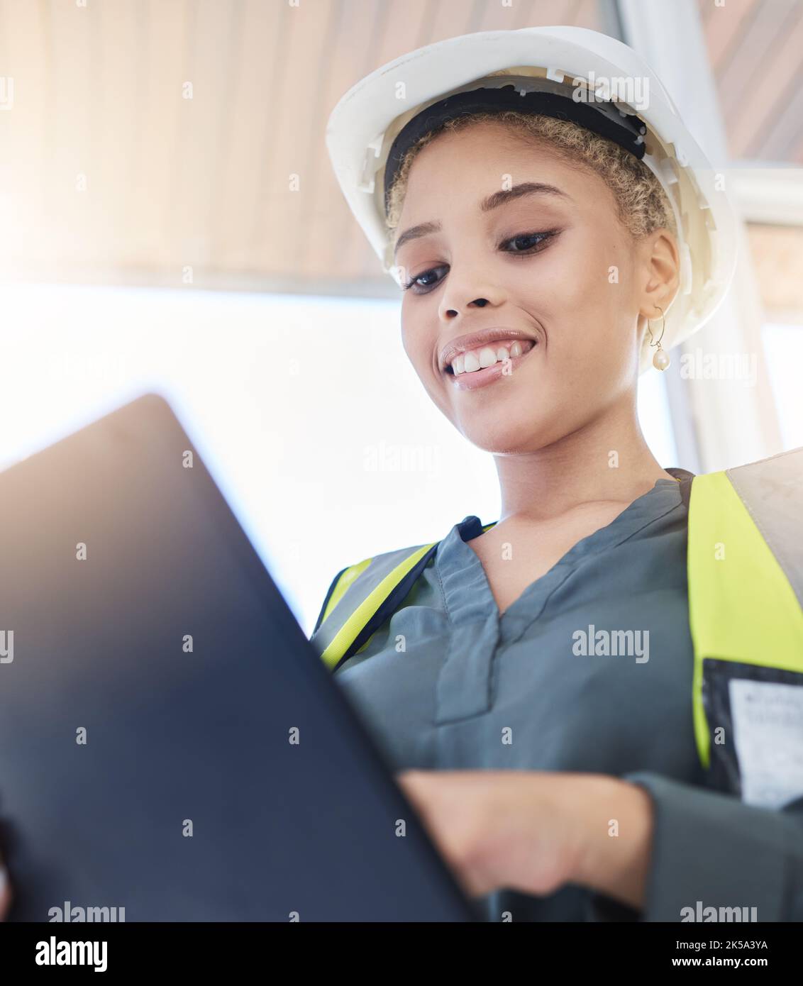 Construction, manager and black woman worker with a tablet logging data ...