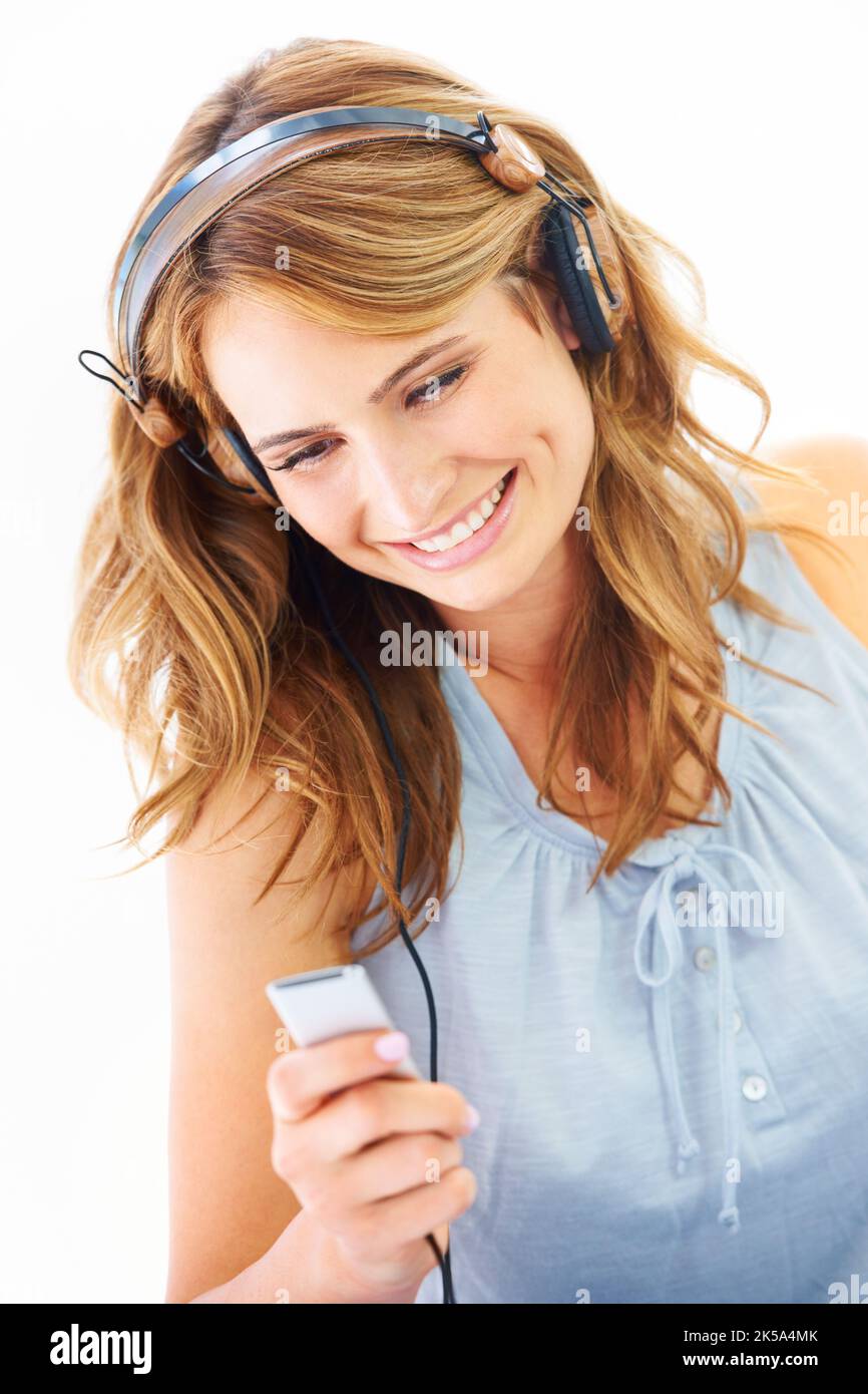 Taking it easy. Young woman listening to music while wearing a pair of ...
