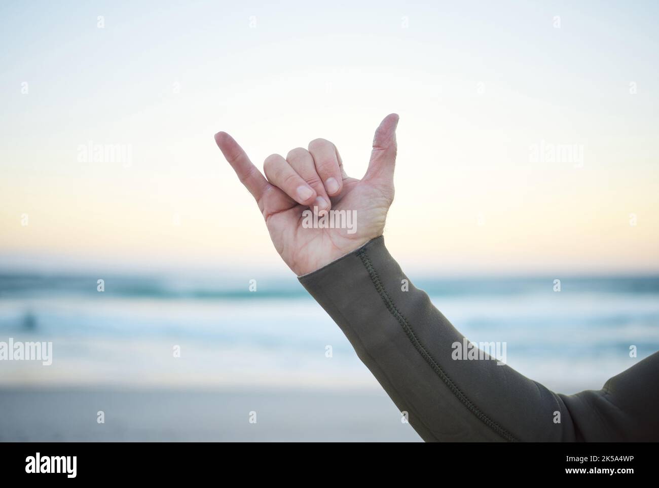 Shaka, surf and sports with the hand sign of a man on the beach for ...