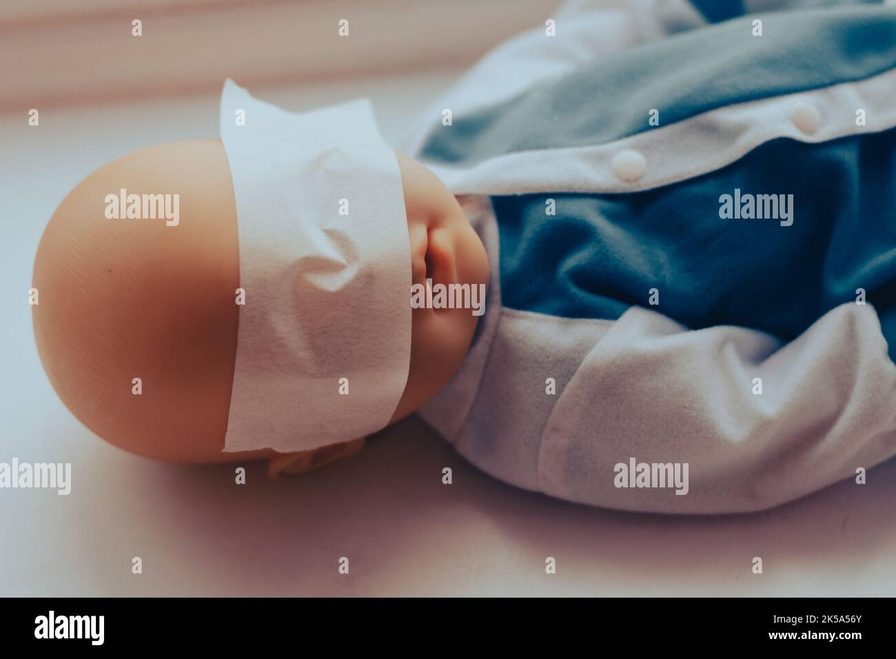 baby doll with taped eyes. child abuse concept. High quality photo ...