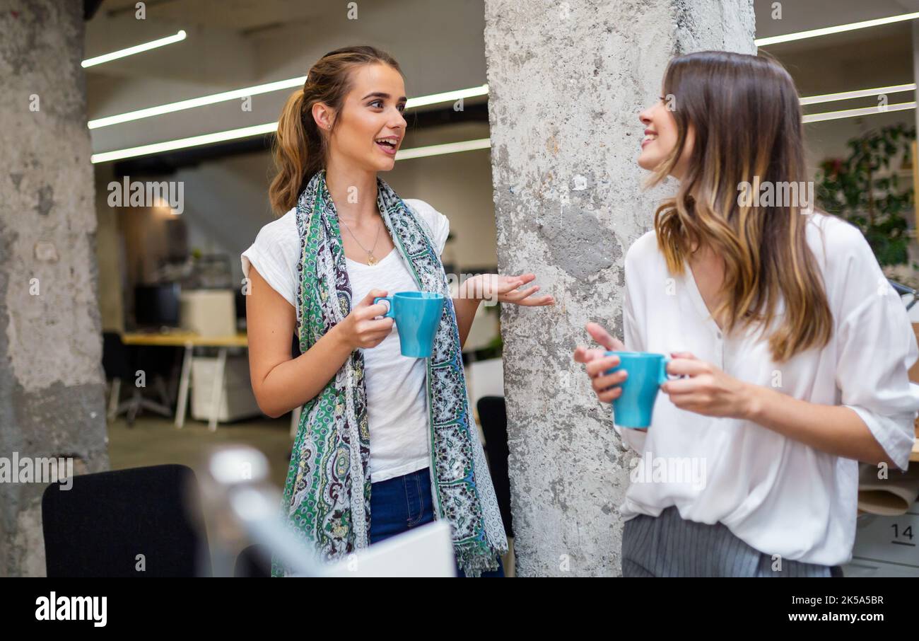 Office coffee break with two business female colleagues having fun ...