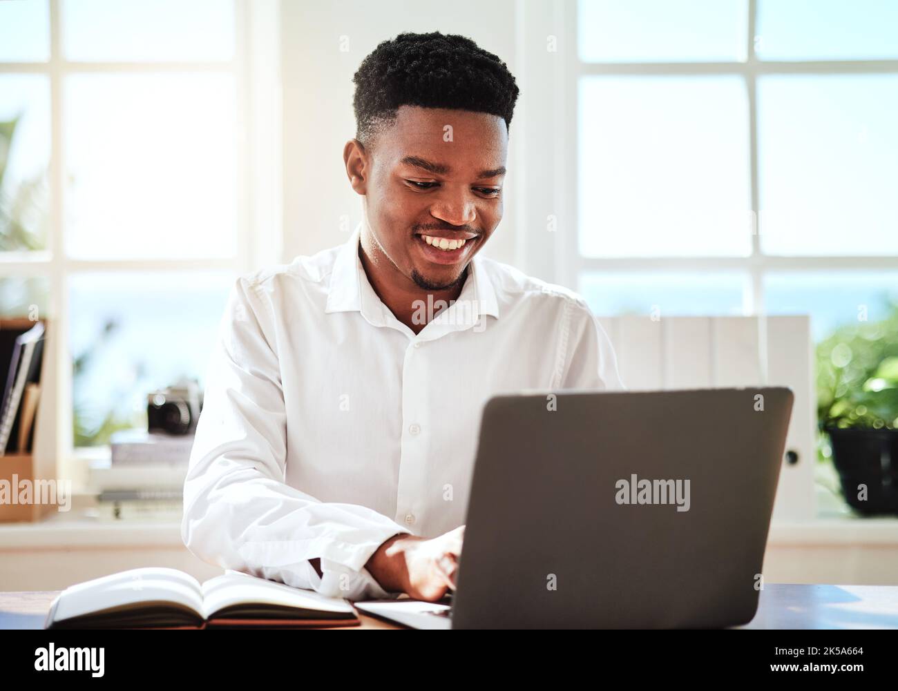 Laptop, typing and schedule with a black man graphic designer working ...