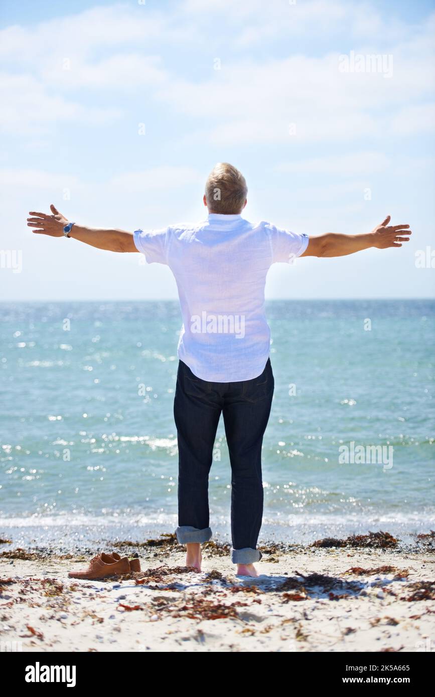 The freedom of retirement. Rear view of a senior man with his arms ...