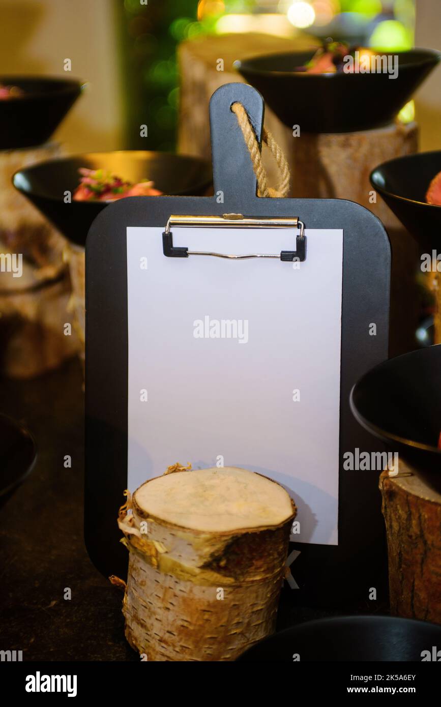 black clipboard with a white paper where you can write on in front of a ...