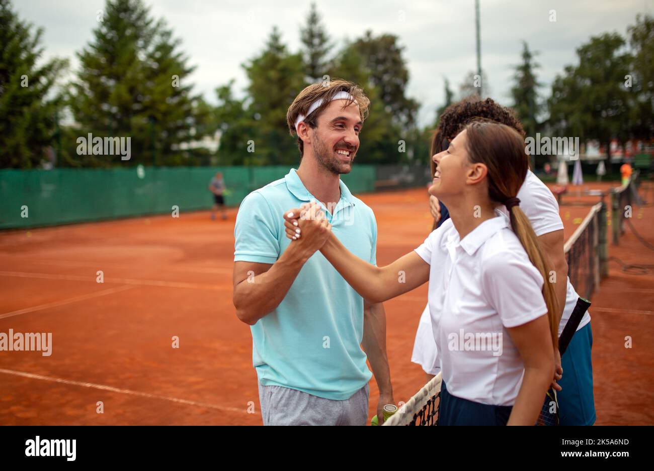 Group of tennis people players giving a handshake after a match Stock ...