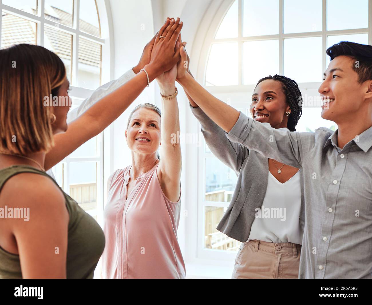 Group, high five and collaboration success on business project in office conference room ...