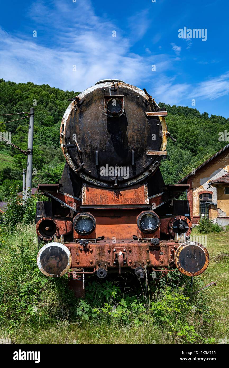The old steam locomotive is parked in a depot in Petrosani, Romania ...