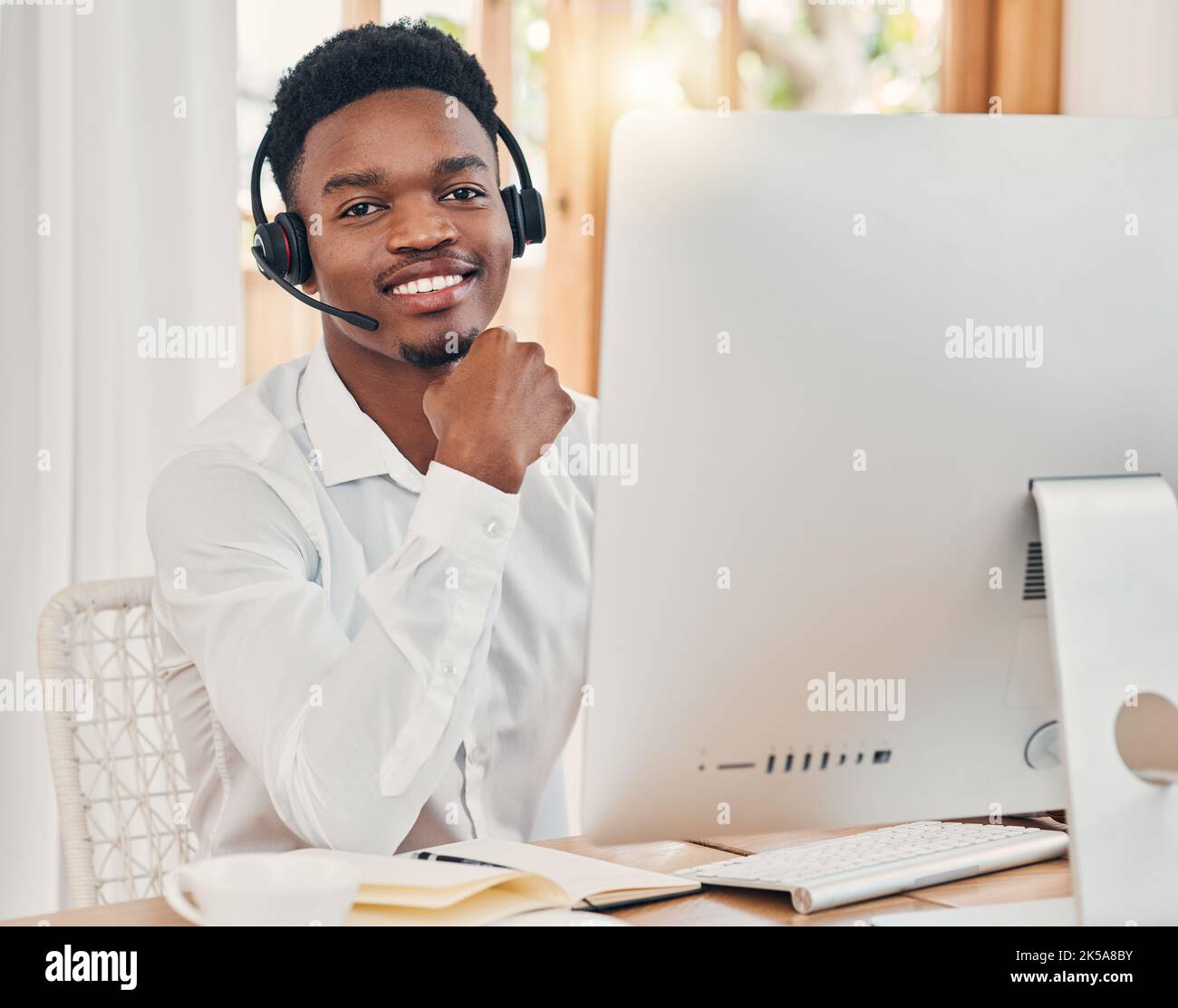 Call center, communication and black man talking with people on the ...