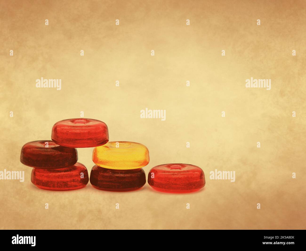 Colorful fruit hard candy on old paper background Stock Photo - Alamy
