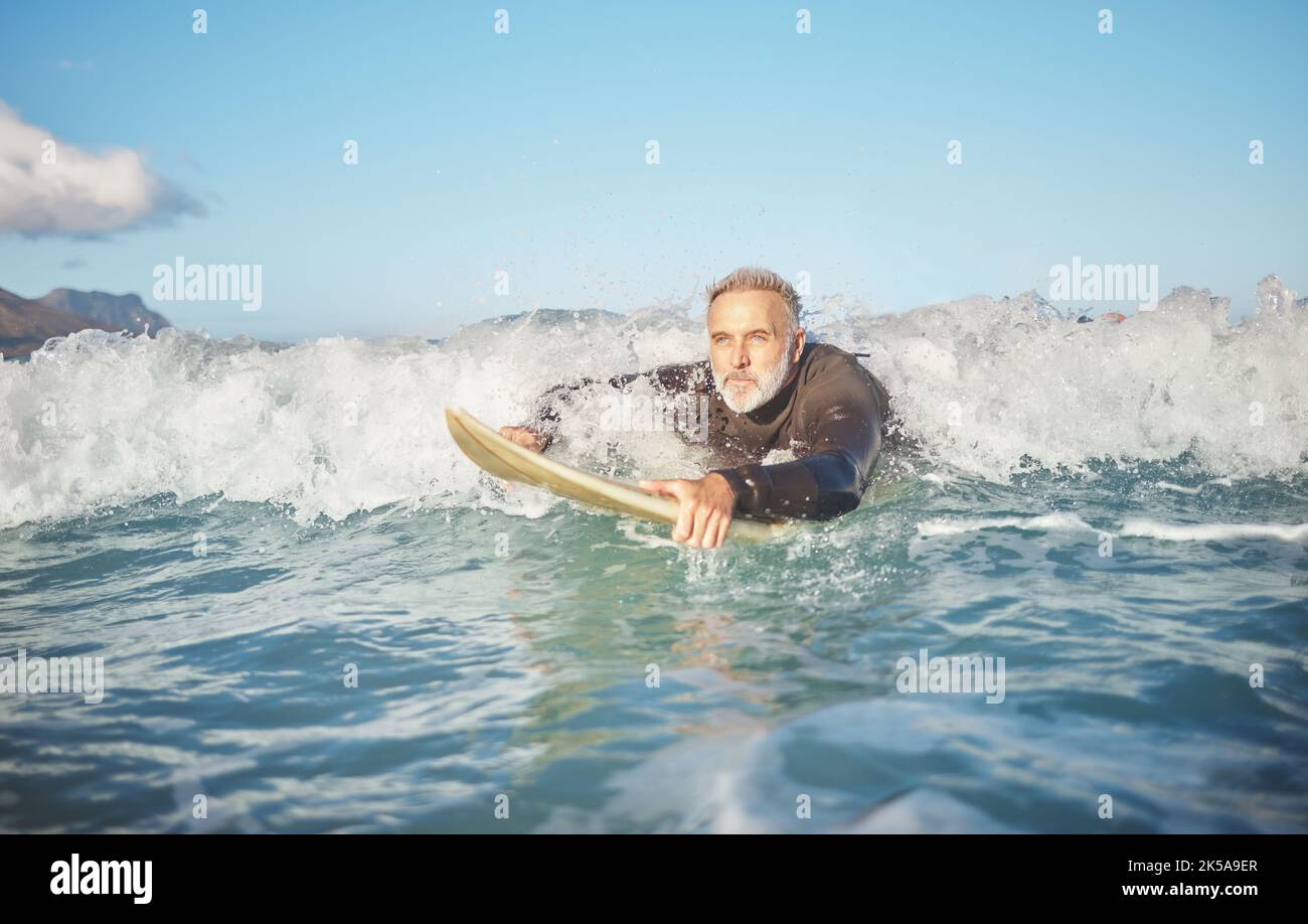 Ocean waves, senior man surfing on beach and healthy fitness lifestyle ...