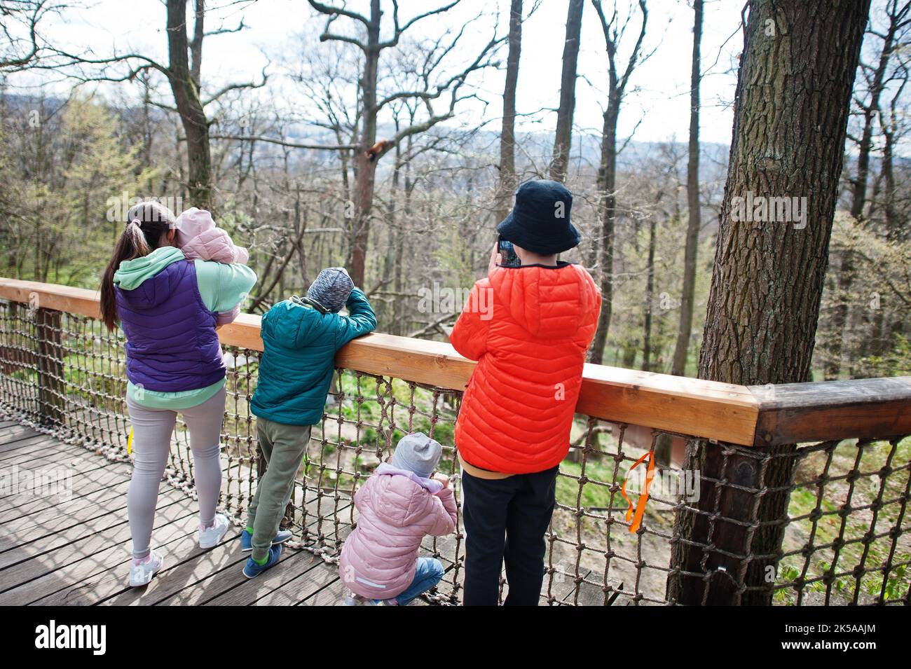Mother with four kids discovering and watching animals at zoo Stock ...