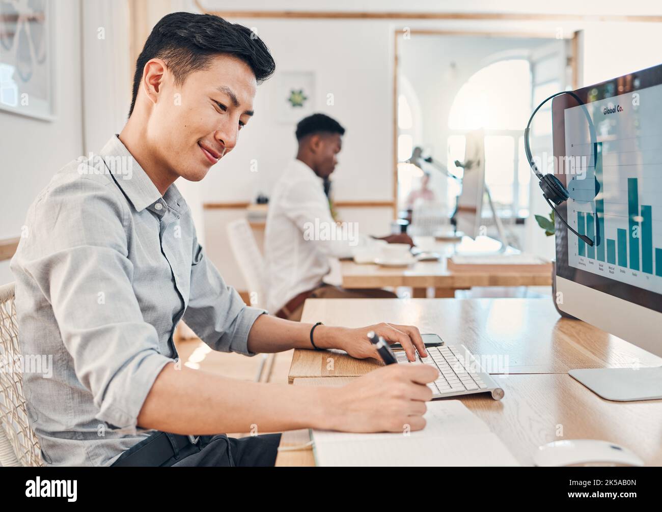 Asian businessman, computer data and writing in office working on ...