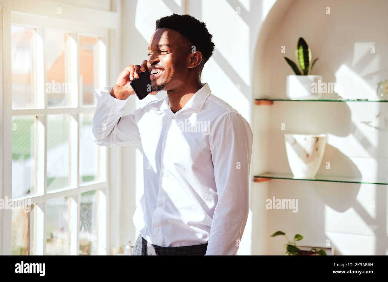 Business, phone call and happy black man in the office, smile on his ...