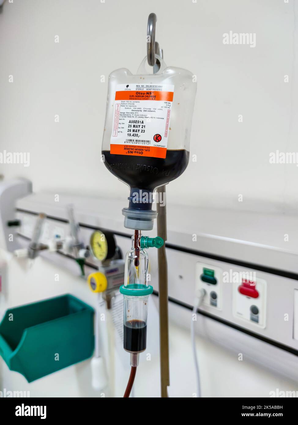 Close up of IV plastic bag with drip chamber in recovery room at ...