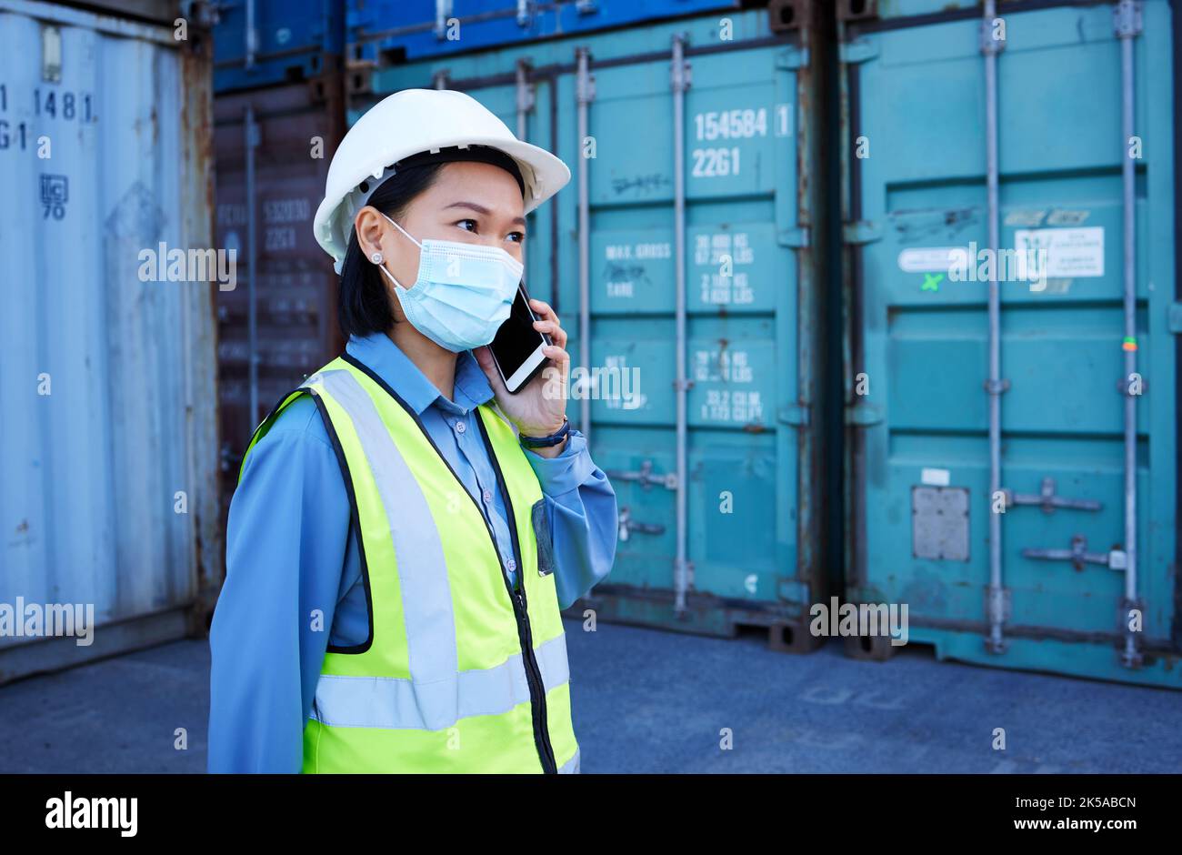 Covid, phone and supply chain logistics with a woman shipping worker on ...