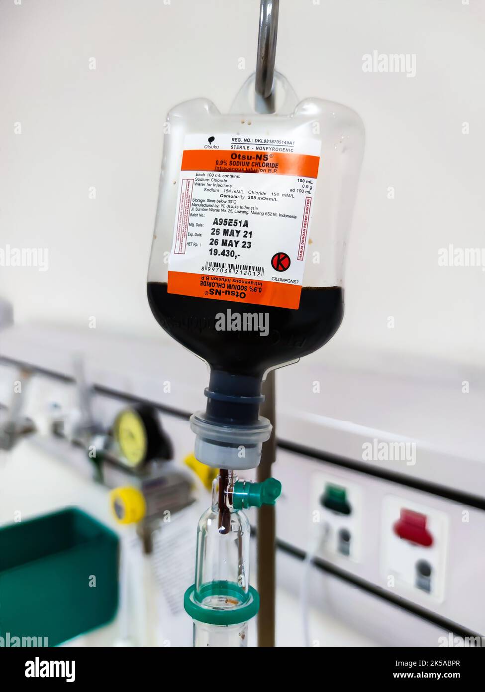 Close up of IV plastic bag with drip chamber in recovery room at ...