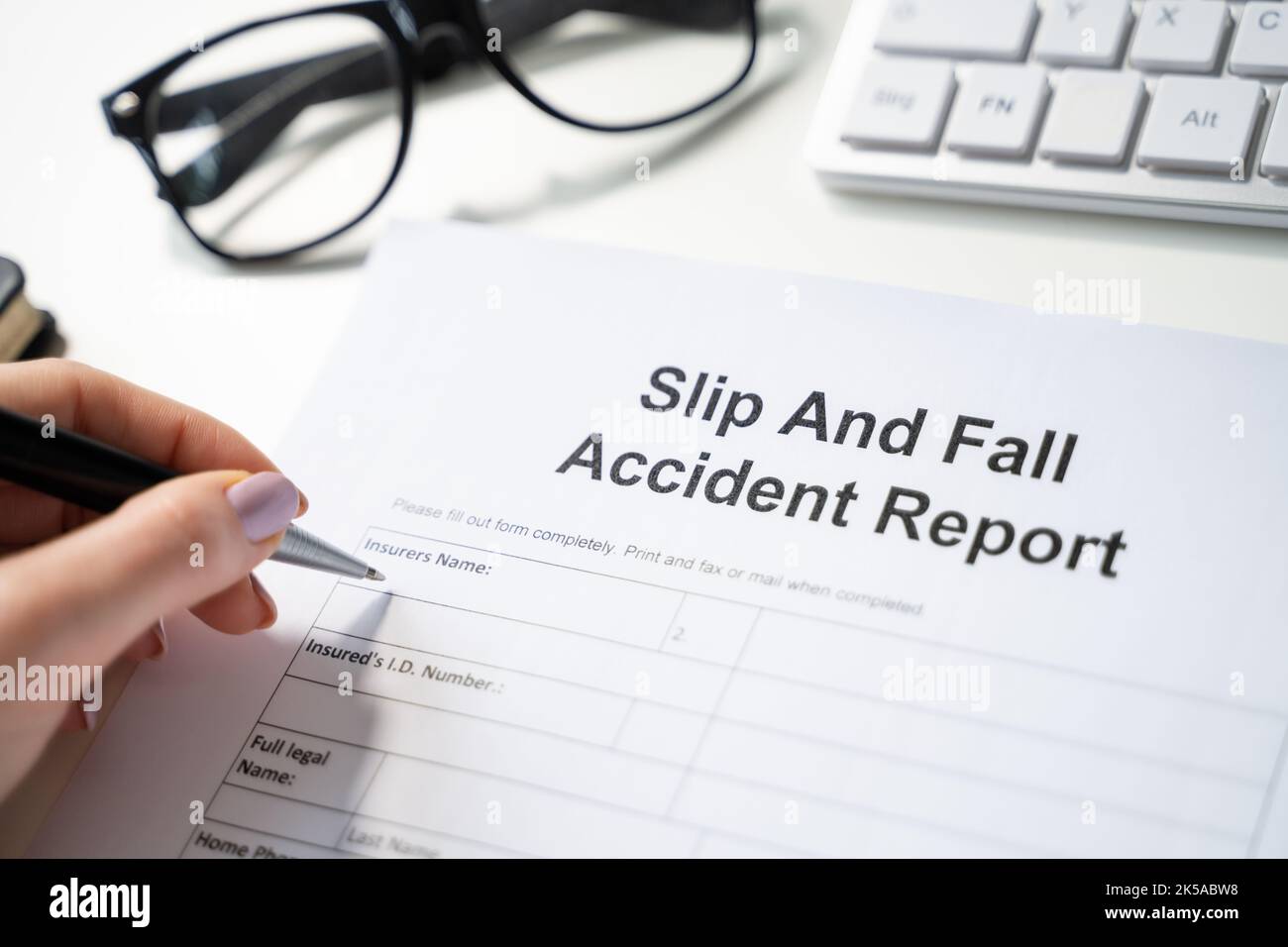 Woman Filling Slip And Fall Accident Report Stock Photo - Alamy