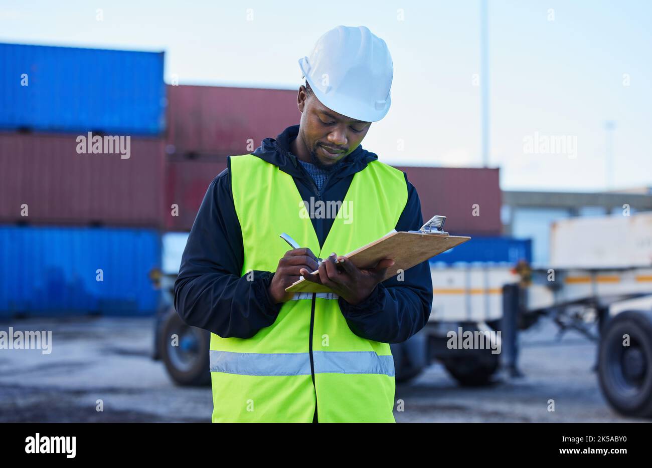 Engineer, cargo and black man writing shipping or delivery inspection ...